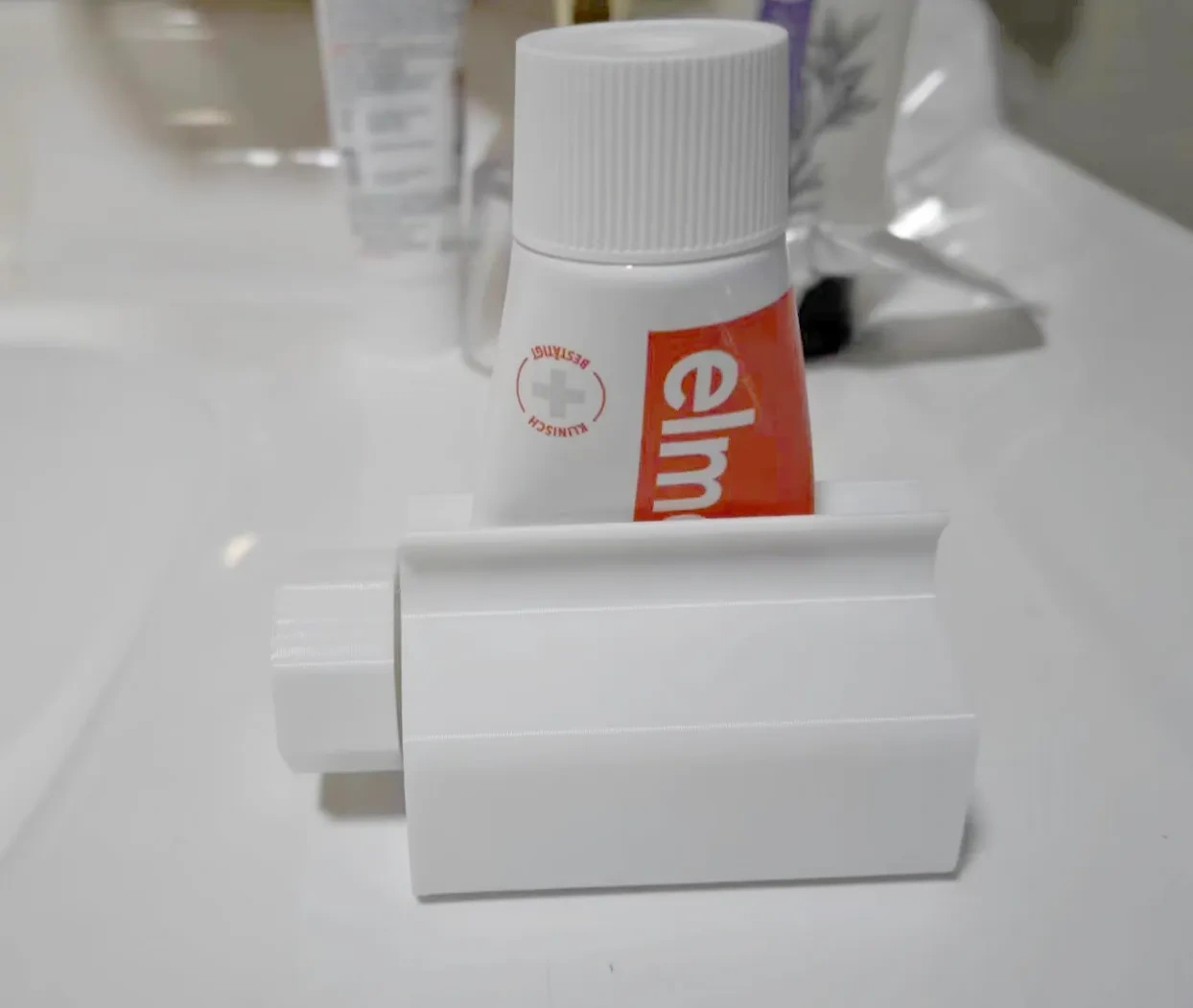 A handy gadget for squeezing out the last bit of toothpaste, also ...