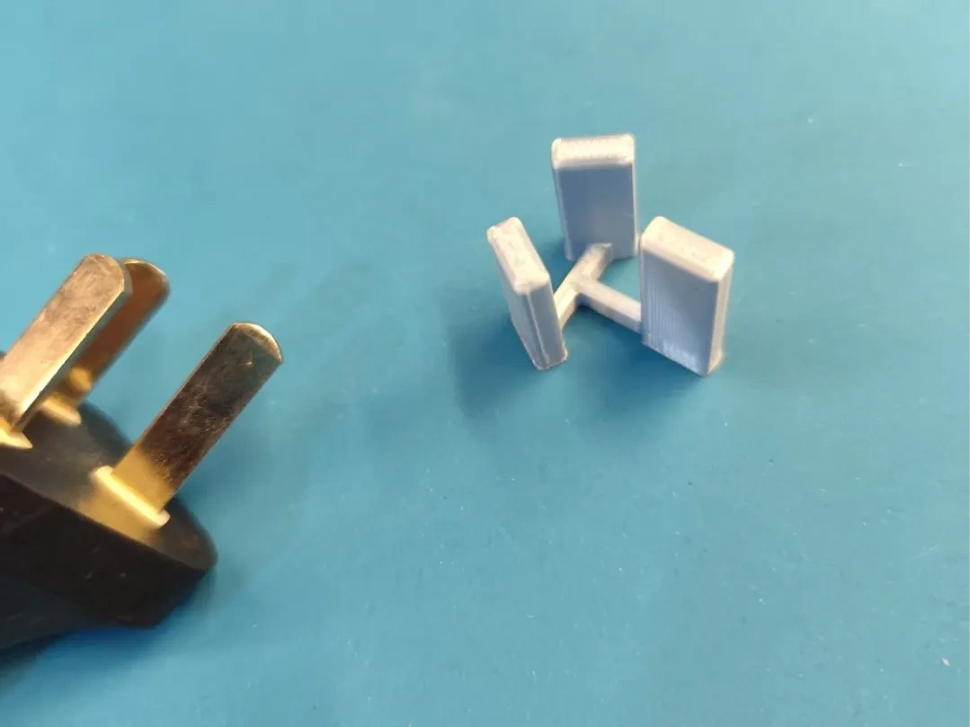 Three-prong plug protector by SEA URCHIN - MakerWorld