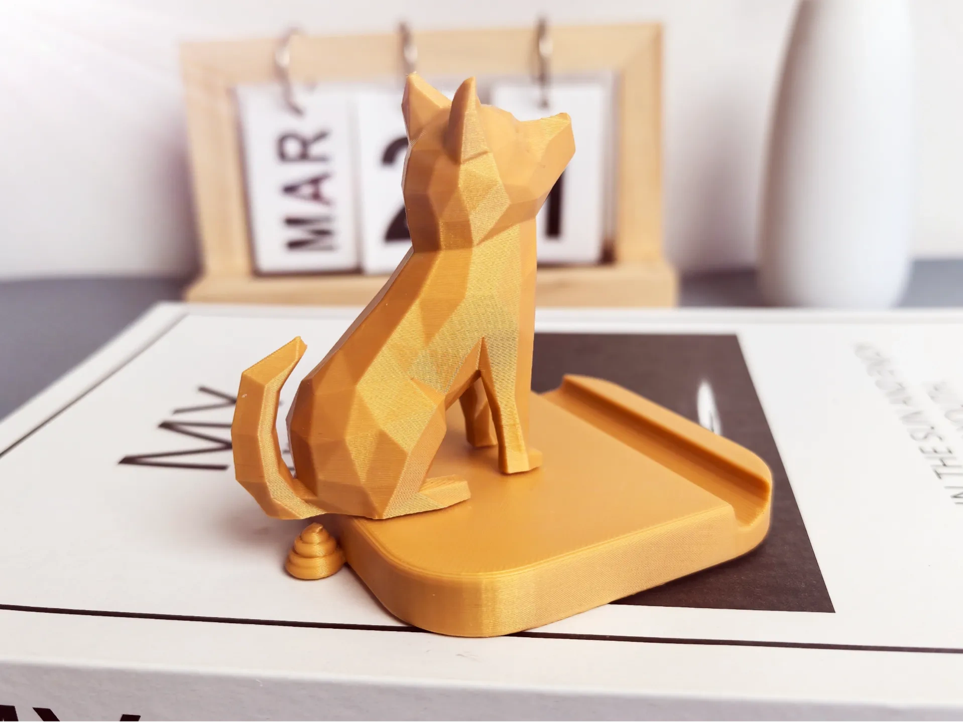 A playful puppy pooping phone stand. A funny little dog taking a dump ...