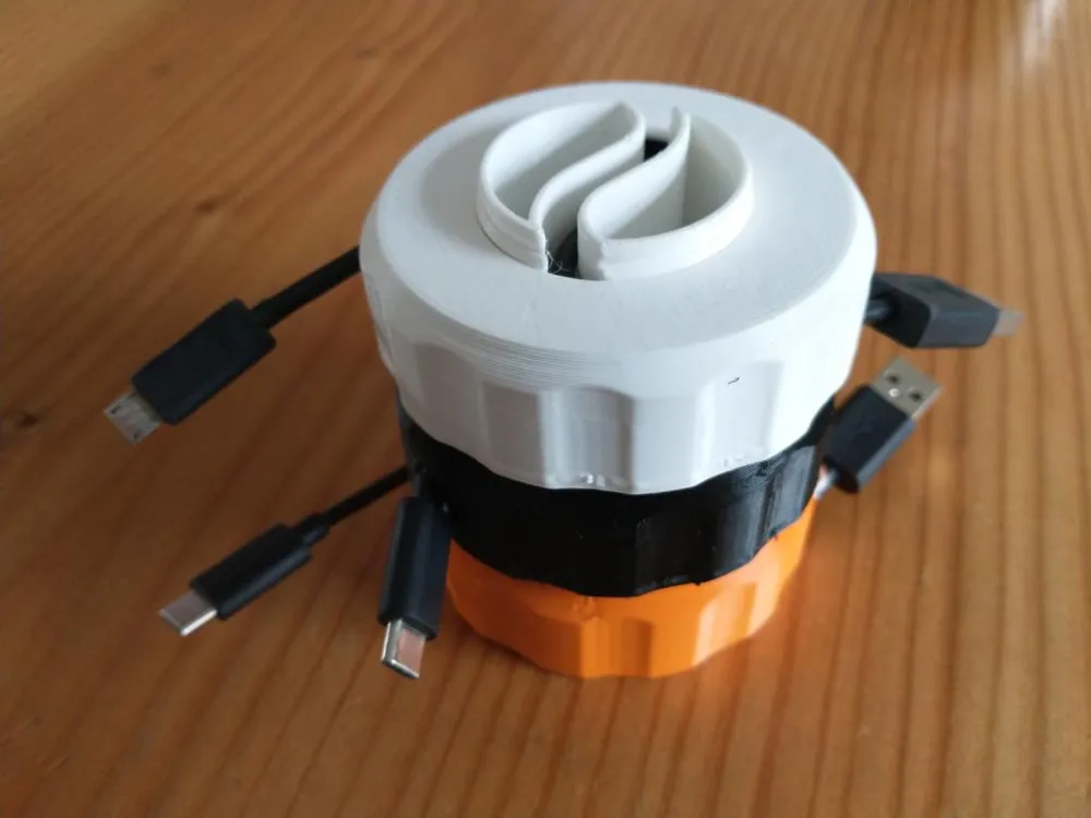 from my Thingiverse: USB cable reel (stackable) by Alwyn MakerWorld ...