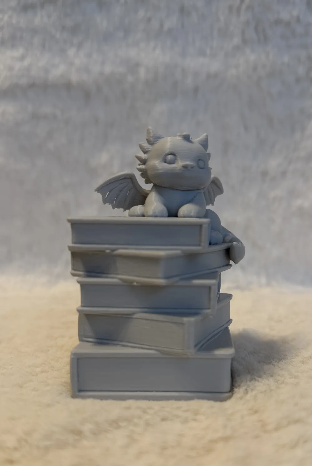 Cute Dragon Figurine on a Stack of Books - Free 3D Print Model - MakerWorld