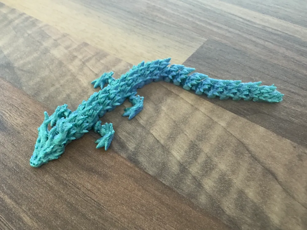 Last filament articulated dragon (6 grams) Remixed by Sven - MakerWorld