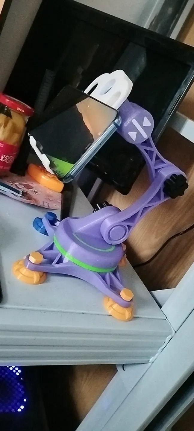 A robotic arm phone holder supports the Bambu Lab Desk Lamp module with ...