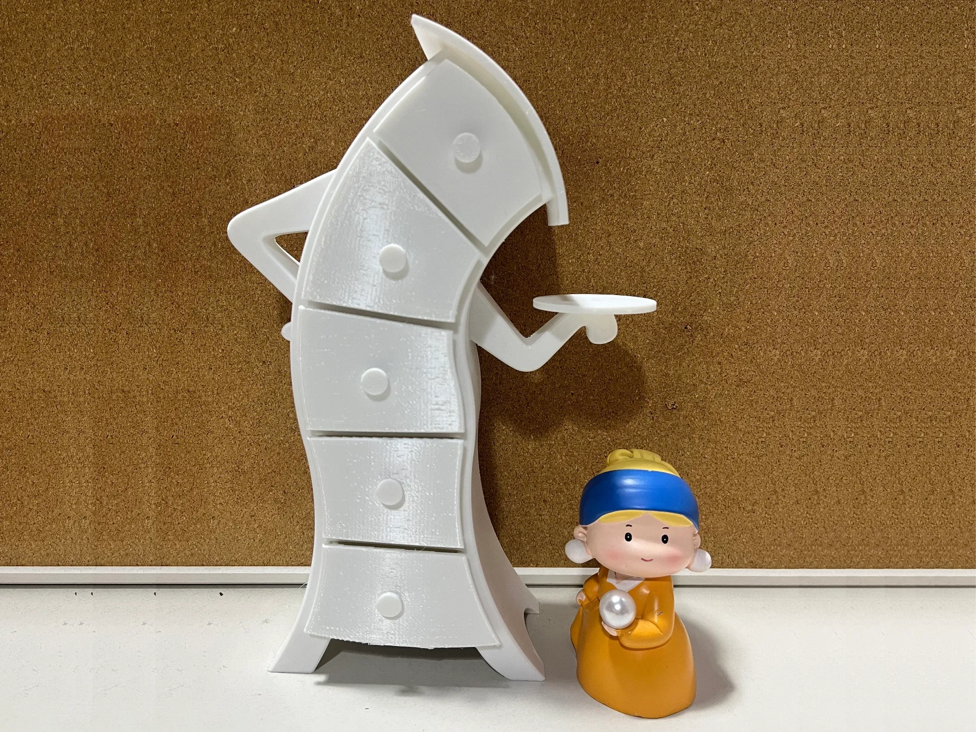 A double-sided chest of drawers with hands akimbo on the desktop by ...